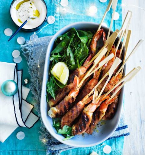 Prawns wrapped in prosciutto, skewered and grilled, served with lemon ...